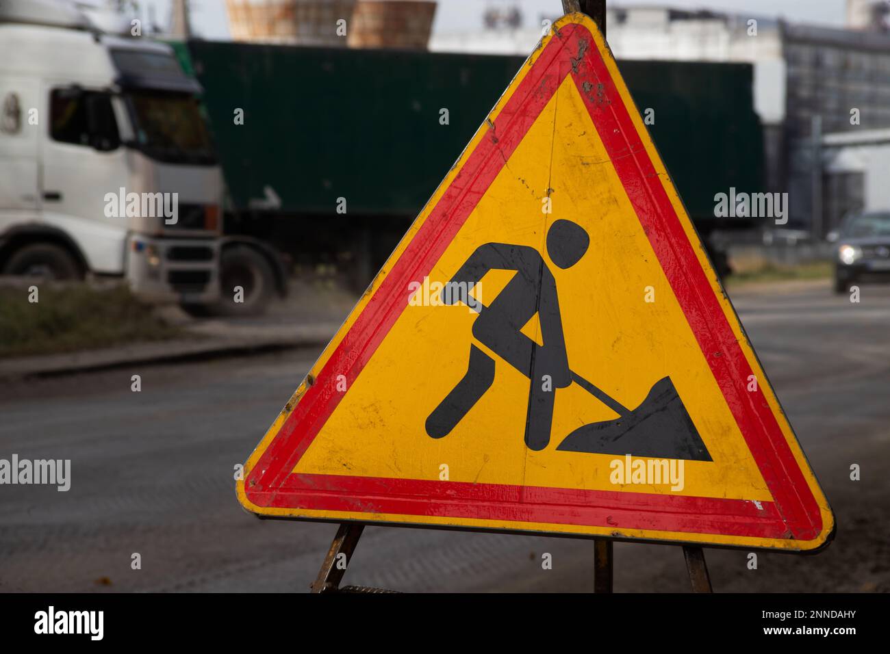 Roadworks warning sign ahead on street sidewalk. Close-up Stock Photo - Alamy