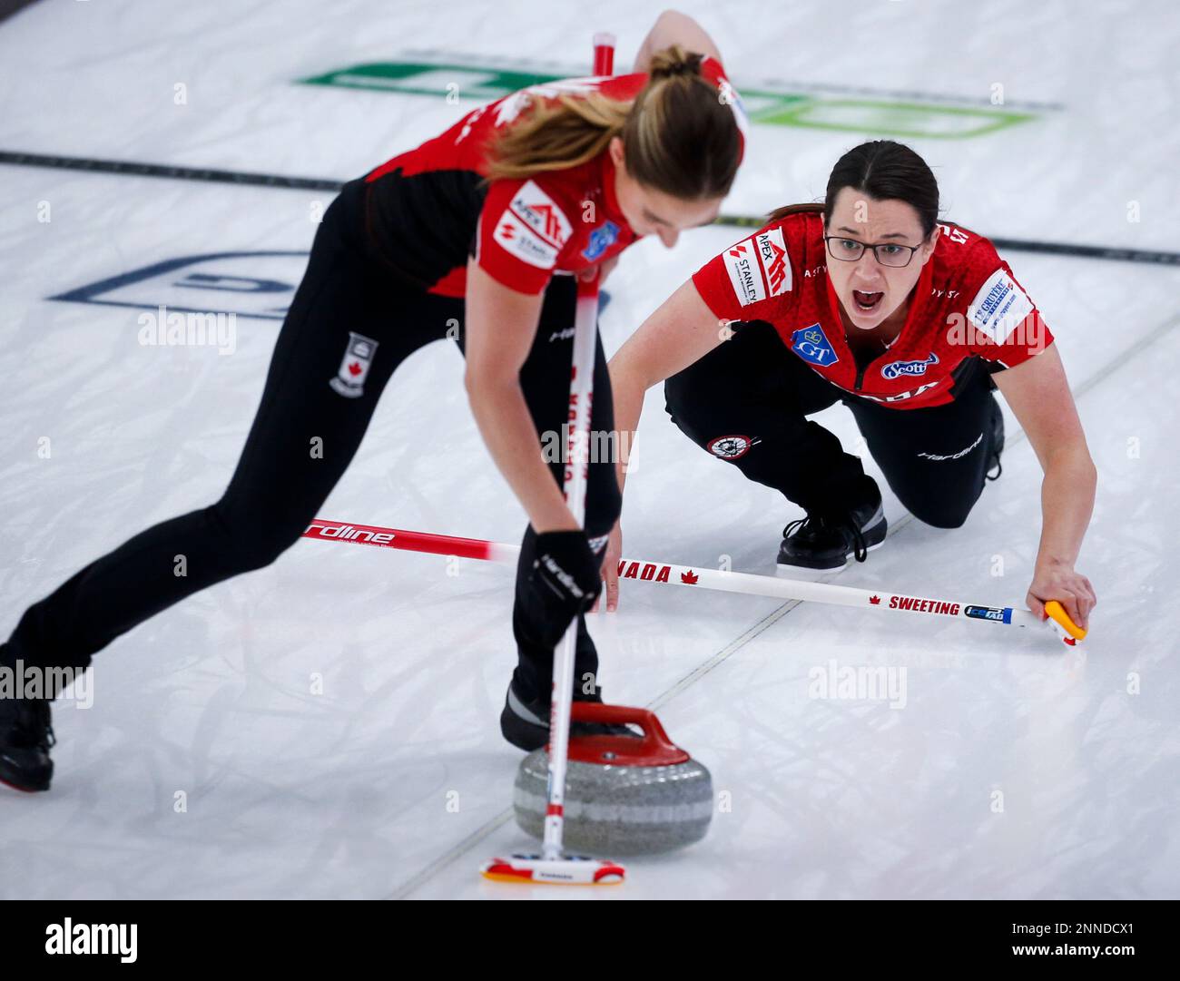 Team Canada third Val Sweeting, right, makes a shot as lead Briane ...