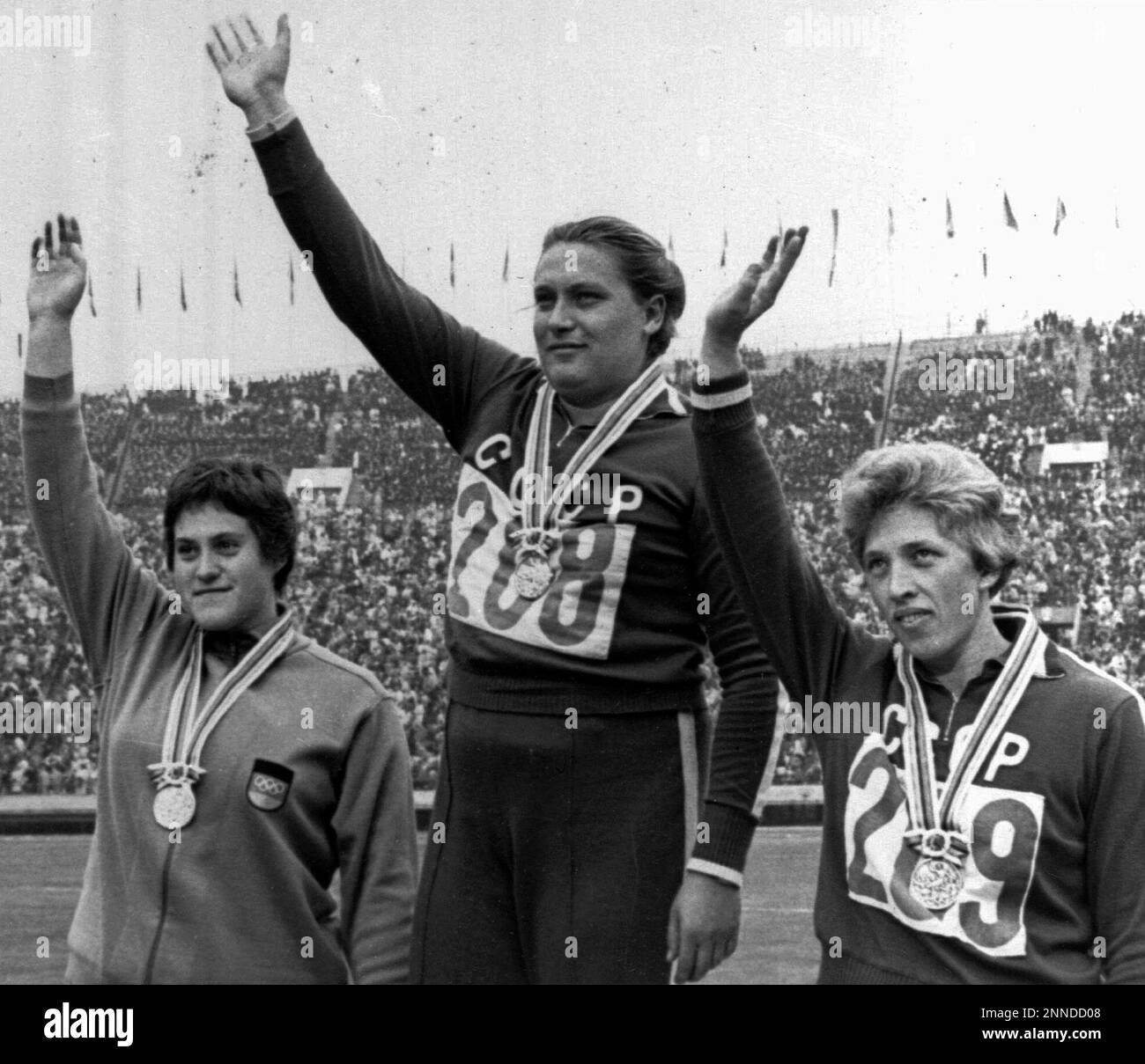 FILE - In this Oct. 20, 1964 file photo, Tamara Press, center, raises ...