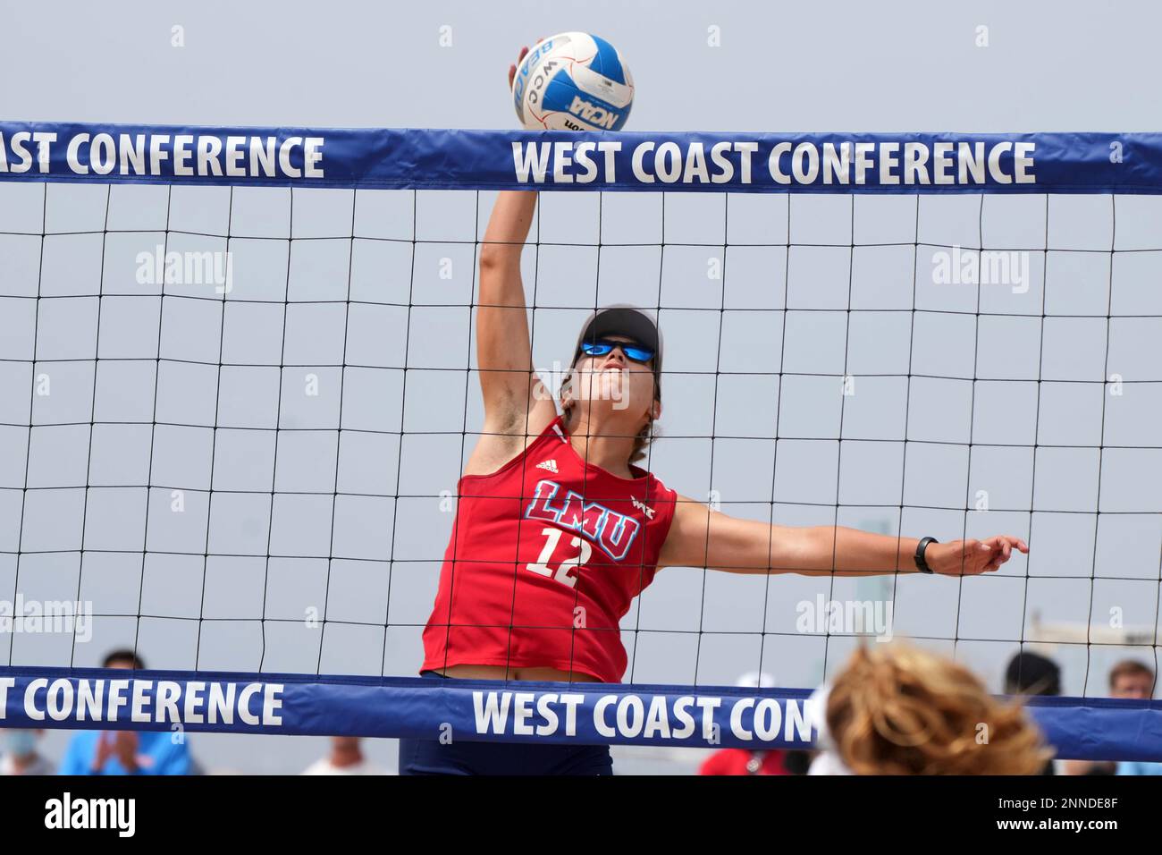 Darby Dunn of Loyola Marymount hits the ball over Gracie Pedersen of ...