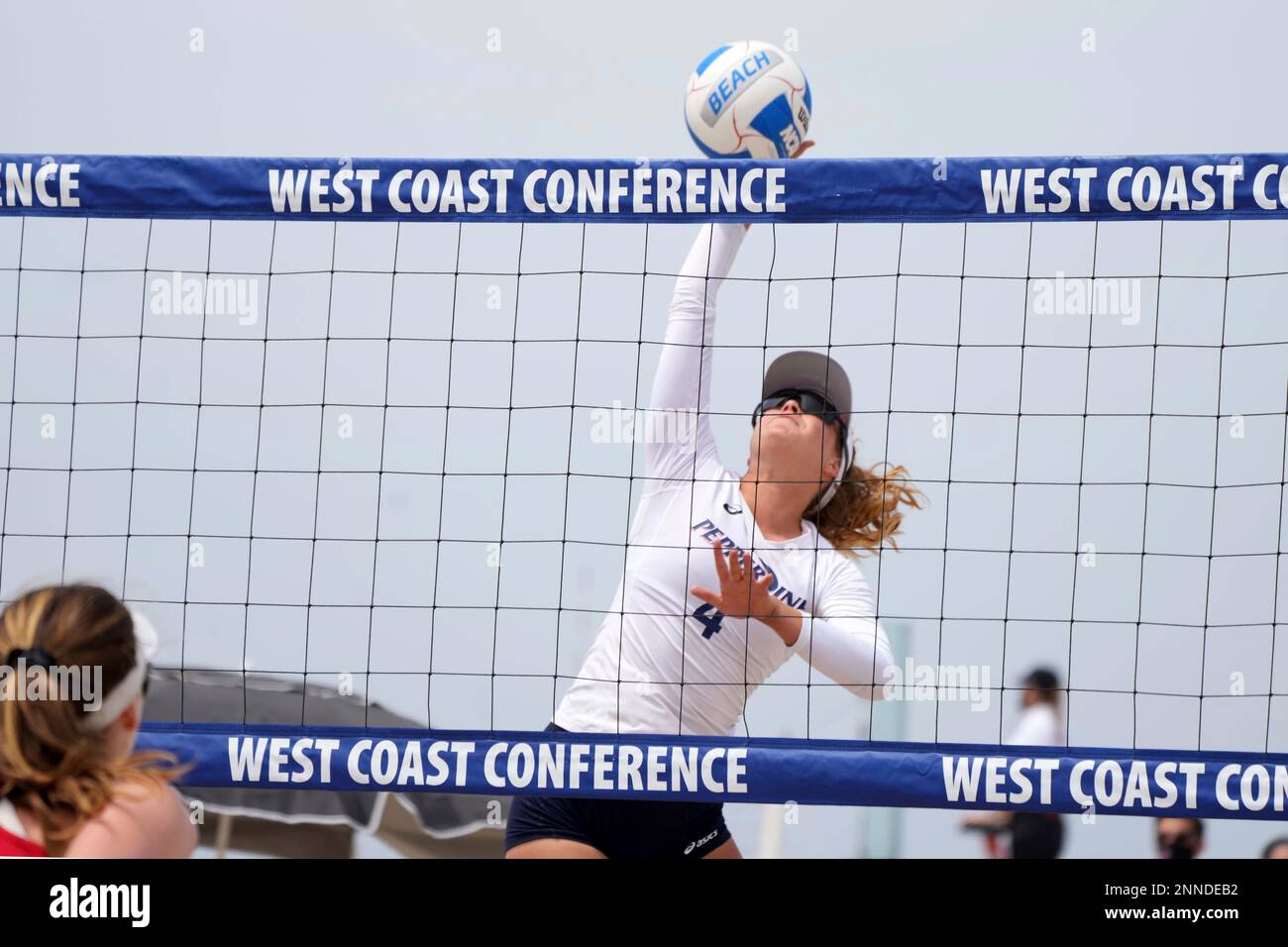 Mary Sinclair of Pepperdine (4) hits the ball against Loyola Marymount ...