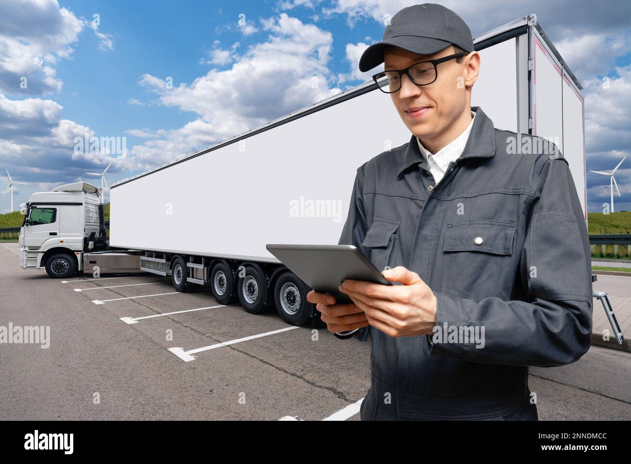 Manager with a digital tablet next to trucks. Fleet management Stock ...