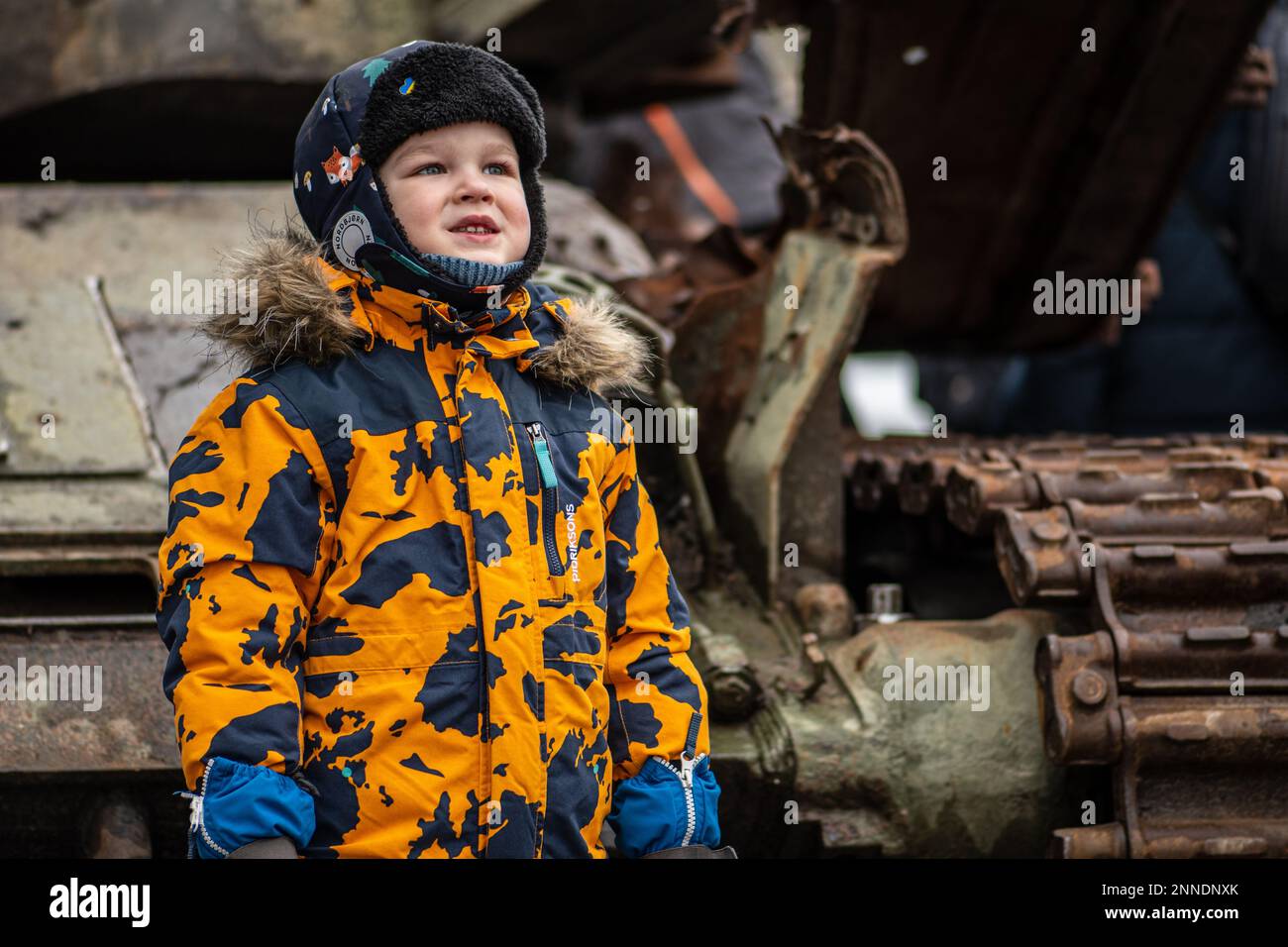 Child photographed near a burnt and melted rusty wreckage of a Soviet ...
