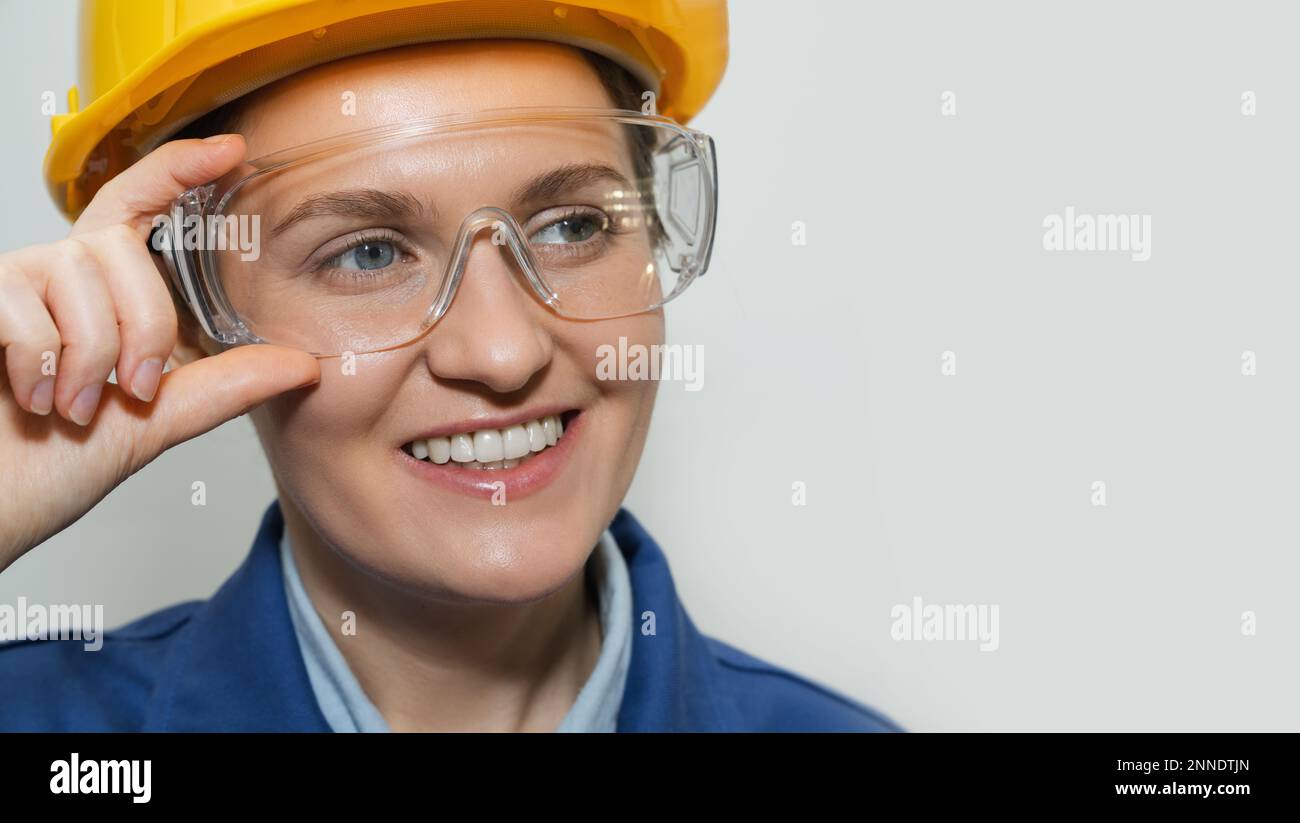 Portrait of a woman engineer in helmet and protective glasses Stock ...