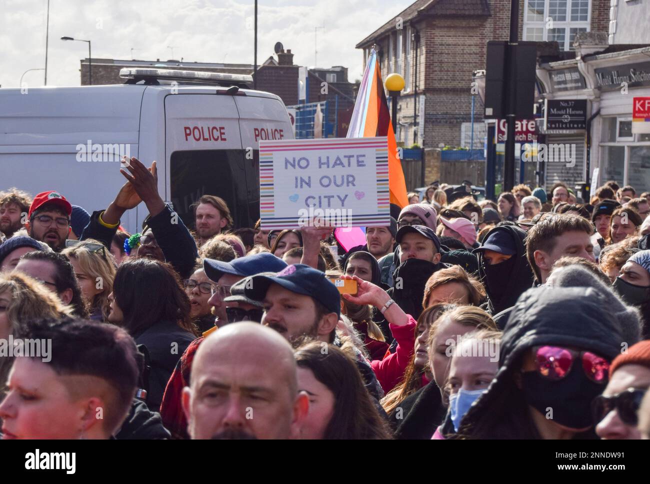 London, UK. 25th Feb, 2023. A pro-LGBTQ counter-protester holds a ...