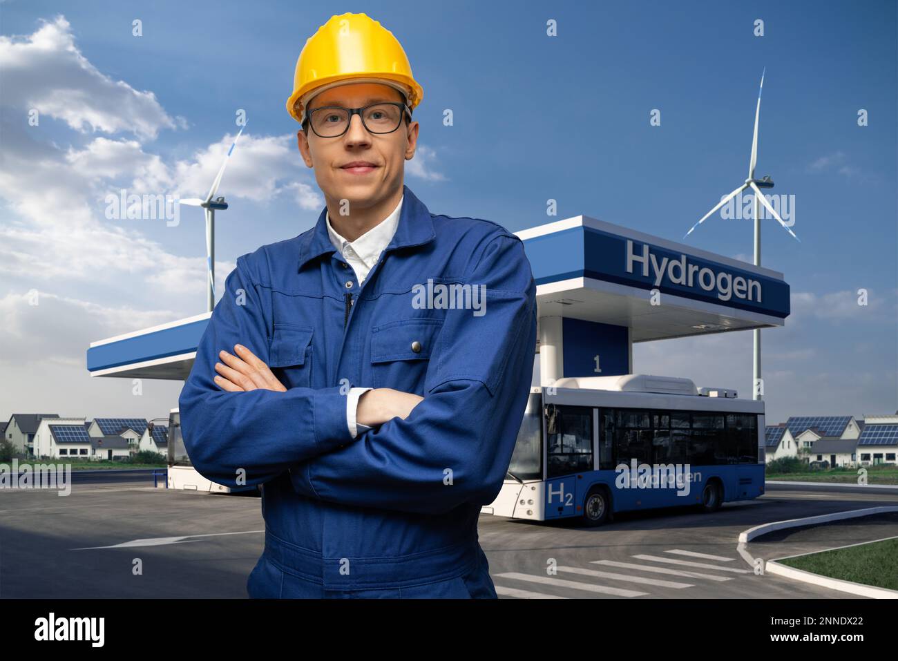 Engineer in a helmet and blue suit on a background of hydrogen filling ...