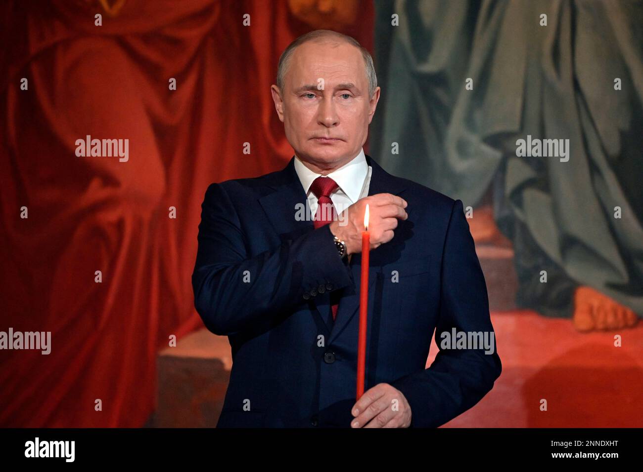 Russian President Vladimir Putin crosses himself during the Easter ...