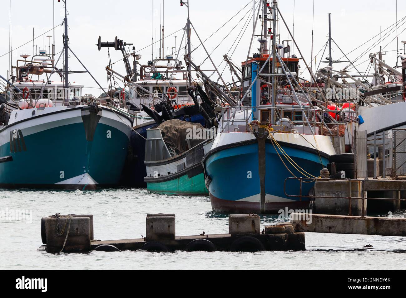 Fishing Trawler Boats Tied To Pier In Harbor Stock Photo - Alamy