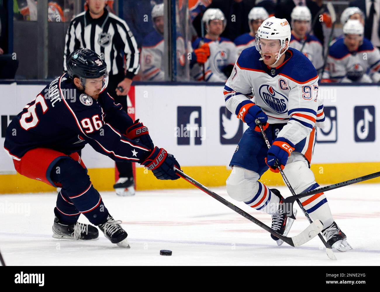 Edmonton Oilers forward Connor McDavid, right, passes the puck in front ...