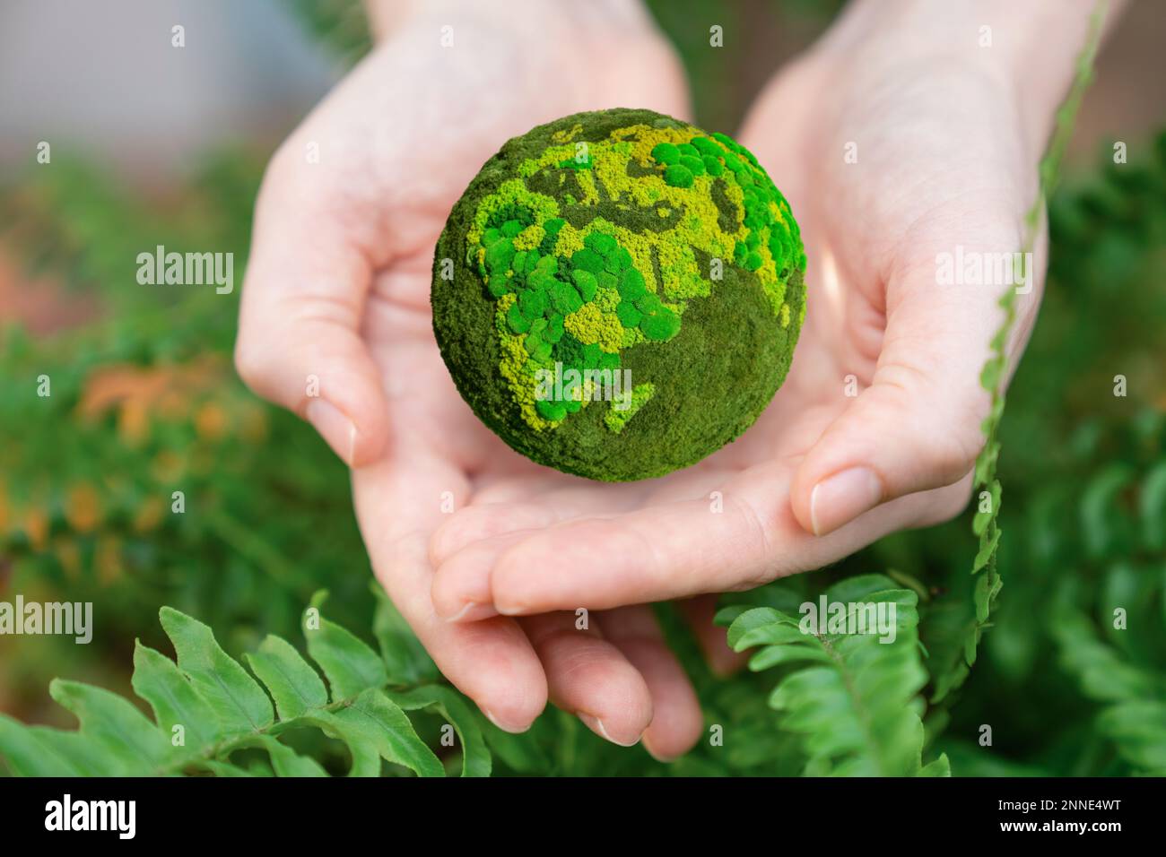 Woman holds a green planet Earth. Symbol of sustainable development and ...