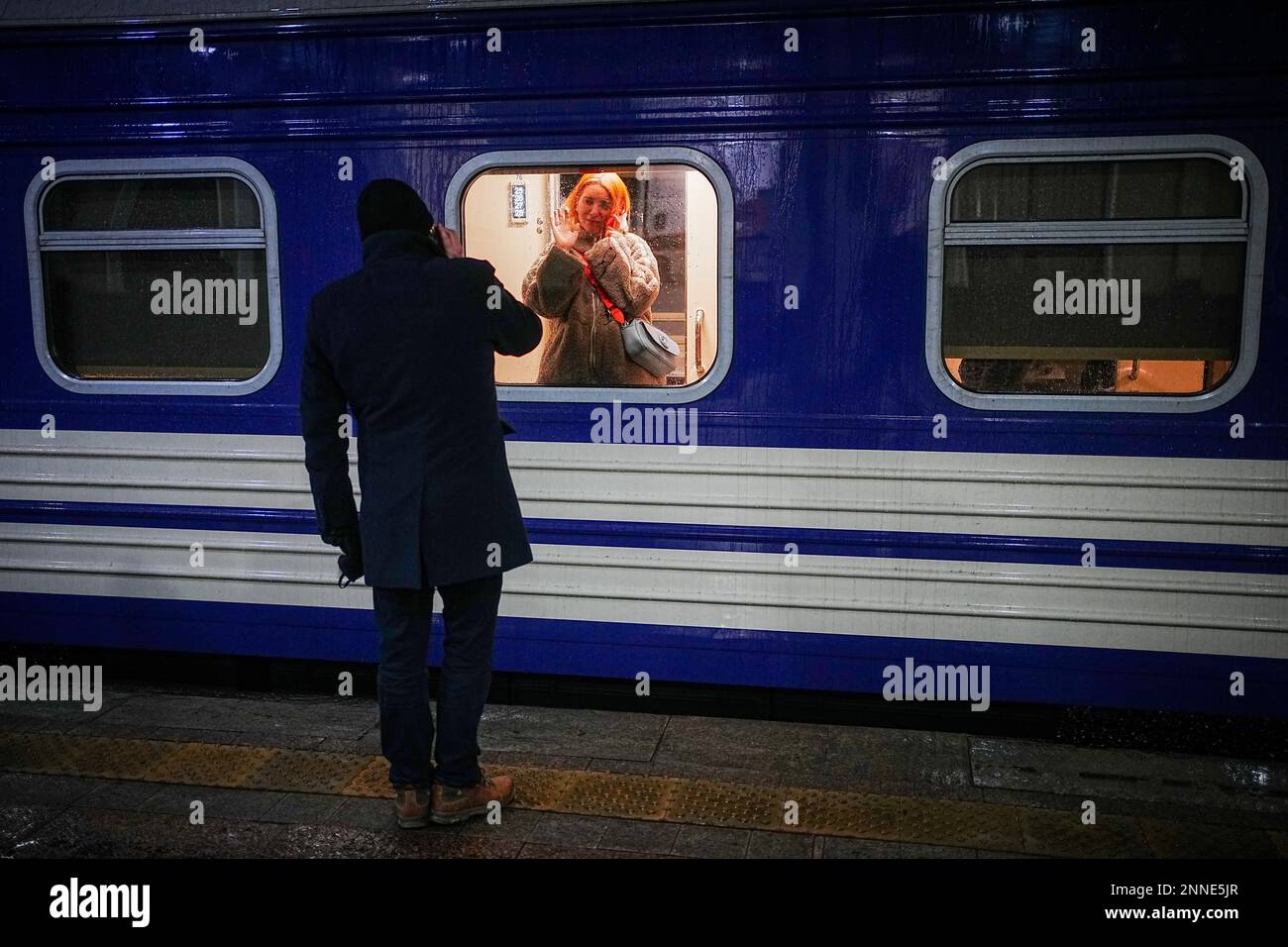 Kiew, Ukraine. 25th Feb, 2023. A couple says goodbye at the main train ...