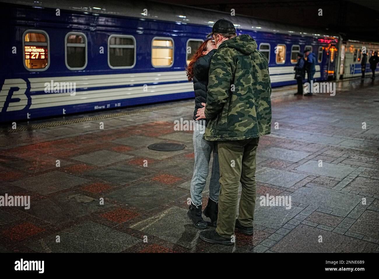 Kiew, Ukraine. 25th Feb, 2023. A couple says goodbye at the main train ...