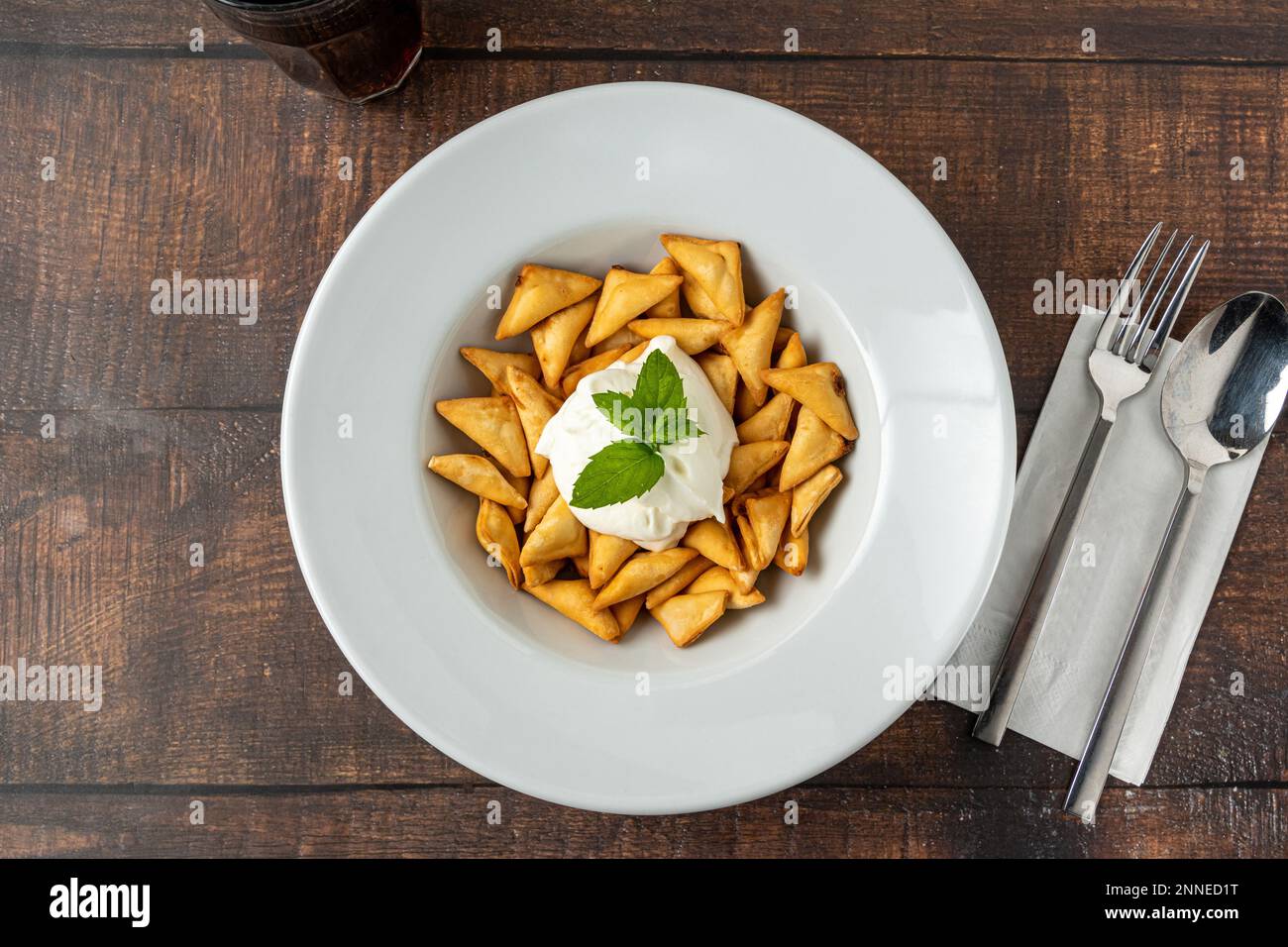 Deep fried crunchy Turkish ravioli or manti on a white porcelain plate ...