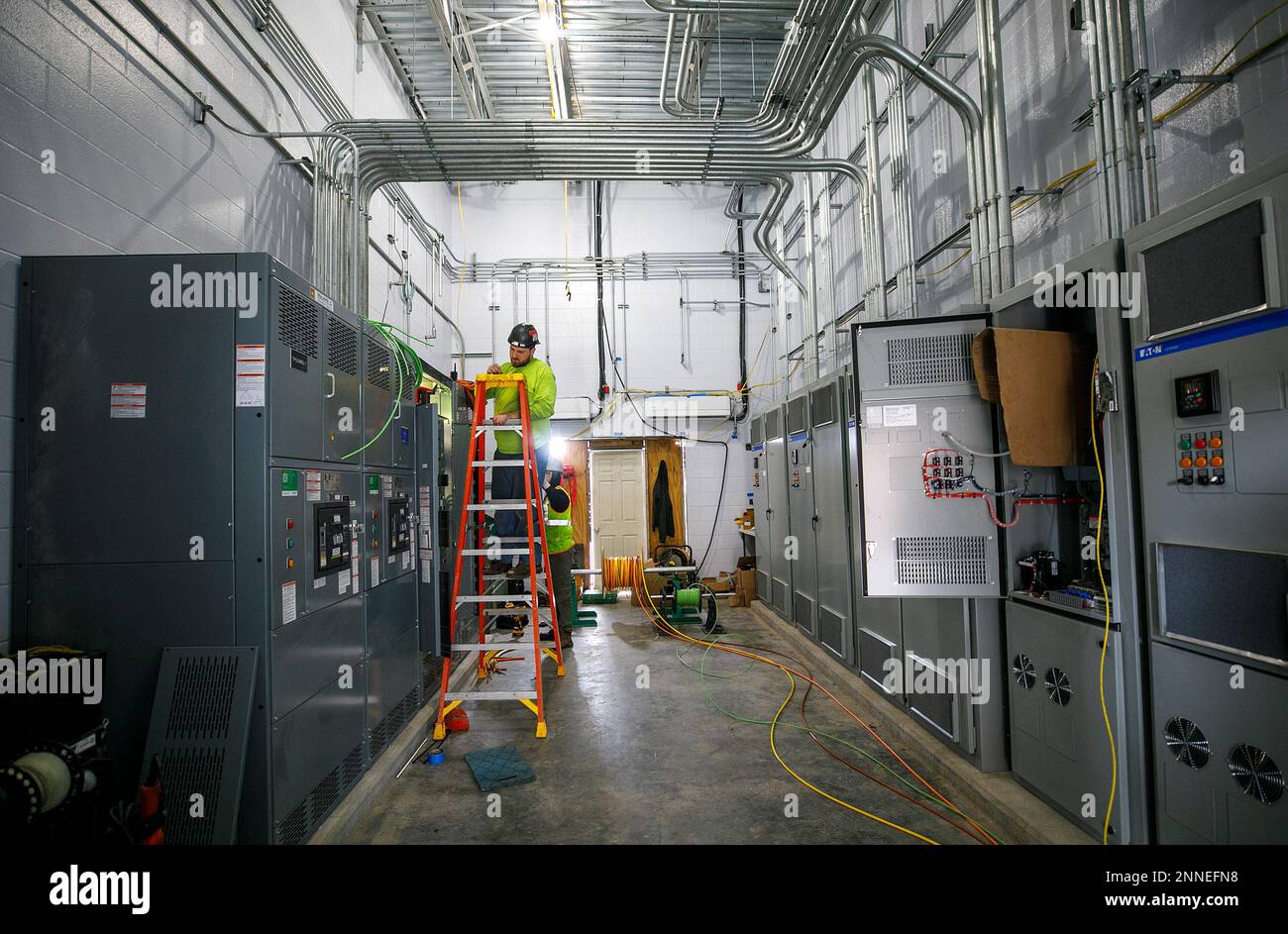 Electricians work on a new instrumentation room in the Tertiary Pump ...
