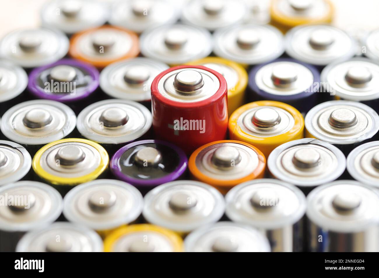 many round batteries and one red battery Stock Photo - Alamy