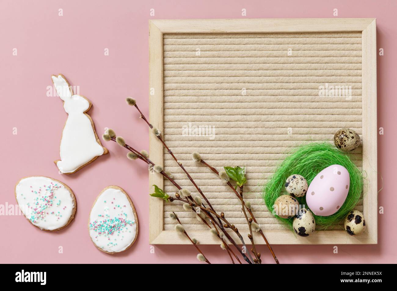 Springtime welcome layout. Letter board, colorful eggs and green ...