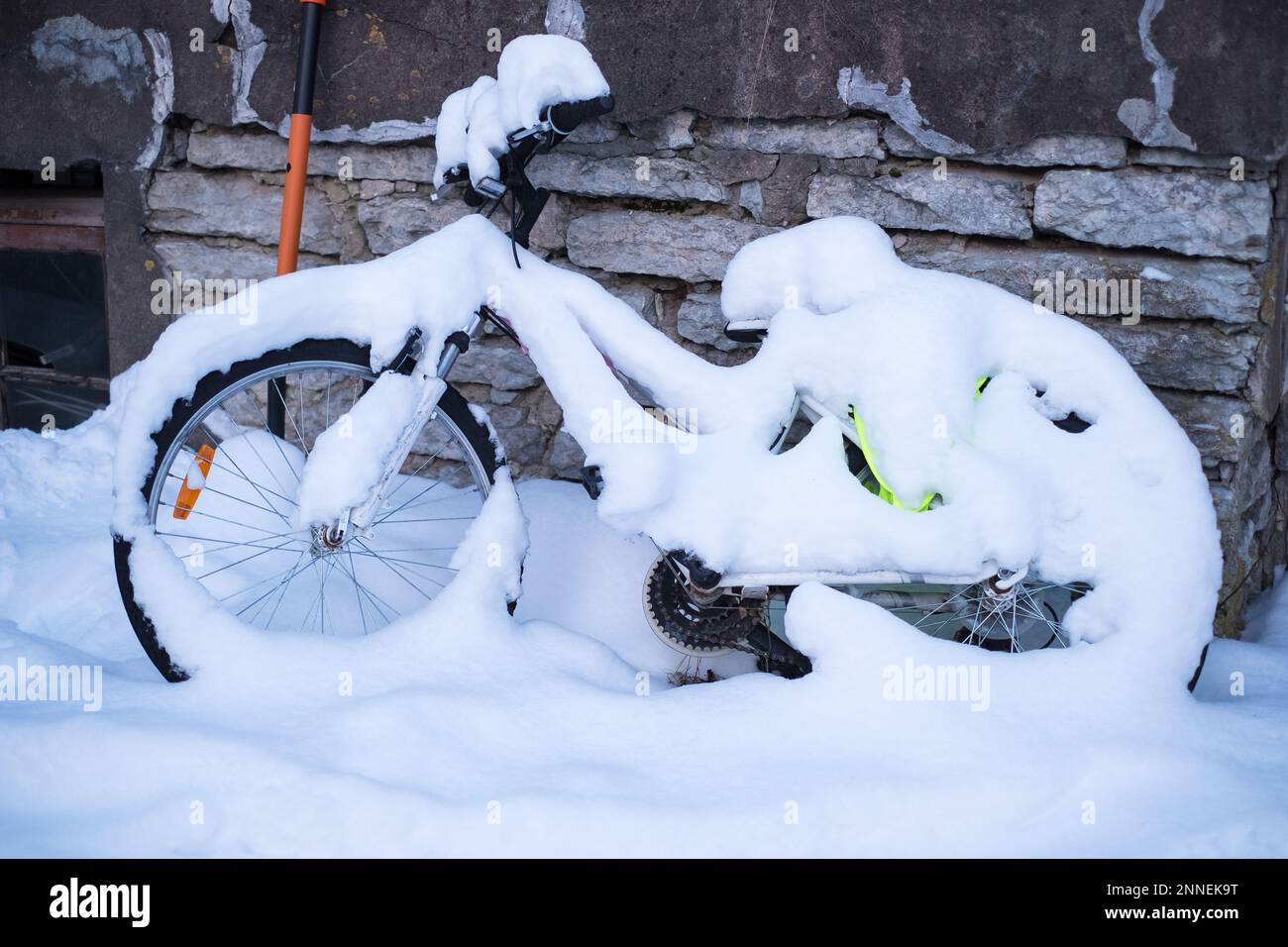 Bike covered with lots of snow. Cold winter weather conditions. Extreme ...