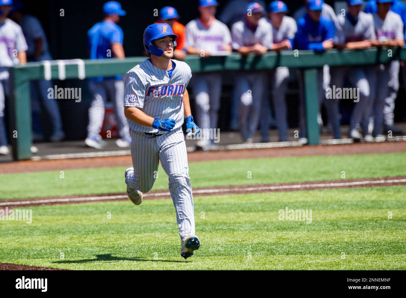 Florida Gators catcher Nathan Hickey (11) hustles down the first-base ...