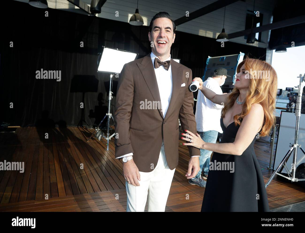 Isla Fisher helps make the final touches to clean the suit of Sacha ...