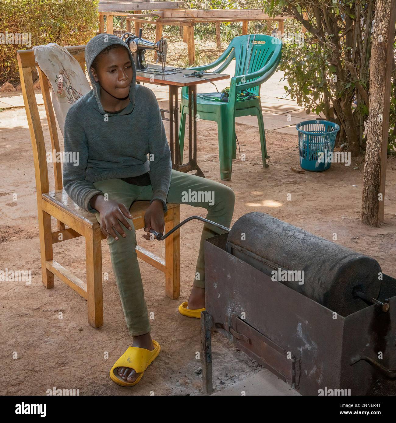 Karatu, Tanzania - October 16th, 2022: A teenage boy roasting coffee ...