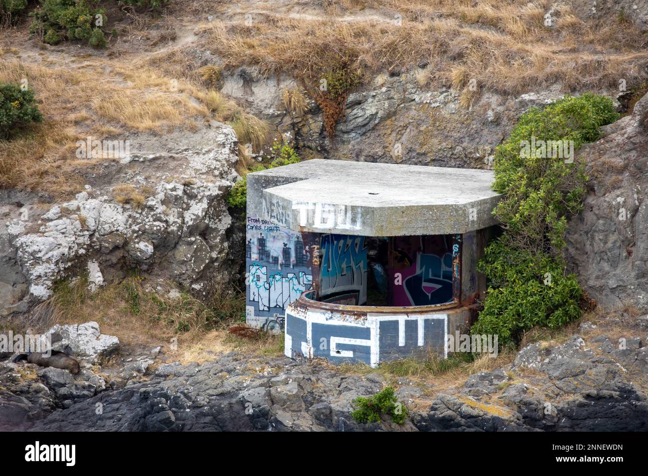 Graffiti tage on concrete bunker on coastal WWII bunker on coastline ...