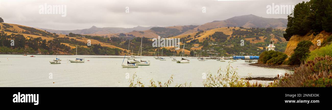 Panorama of Akaroa, New Zealand waterfront and Akaroa Head Lighthouse ...