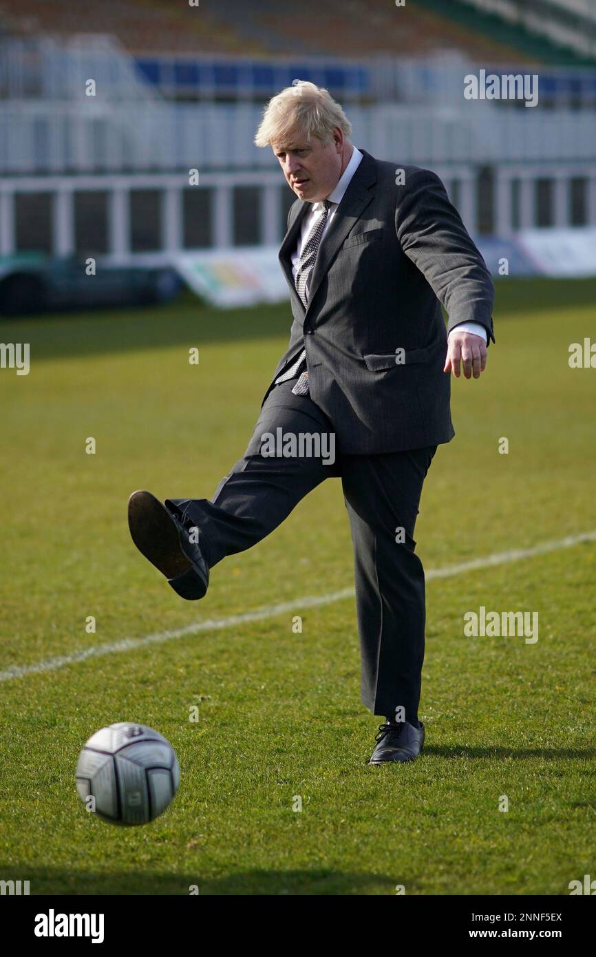 Britain's Prime Minister Boris Johnson kicks a soccer ball during a ...