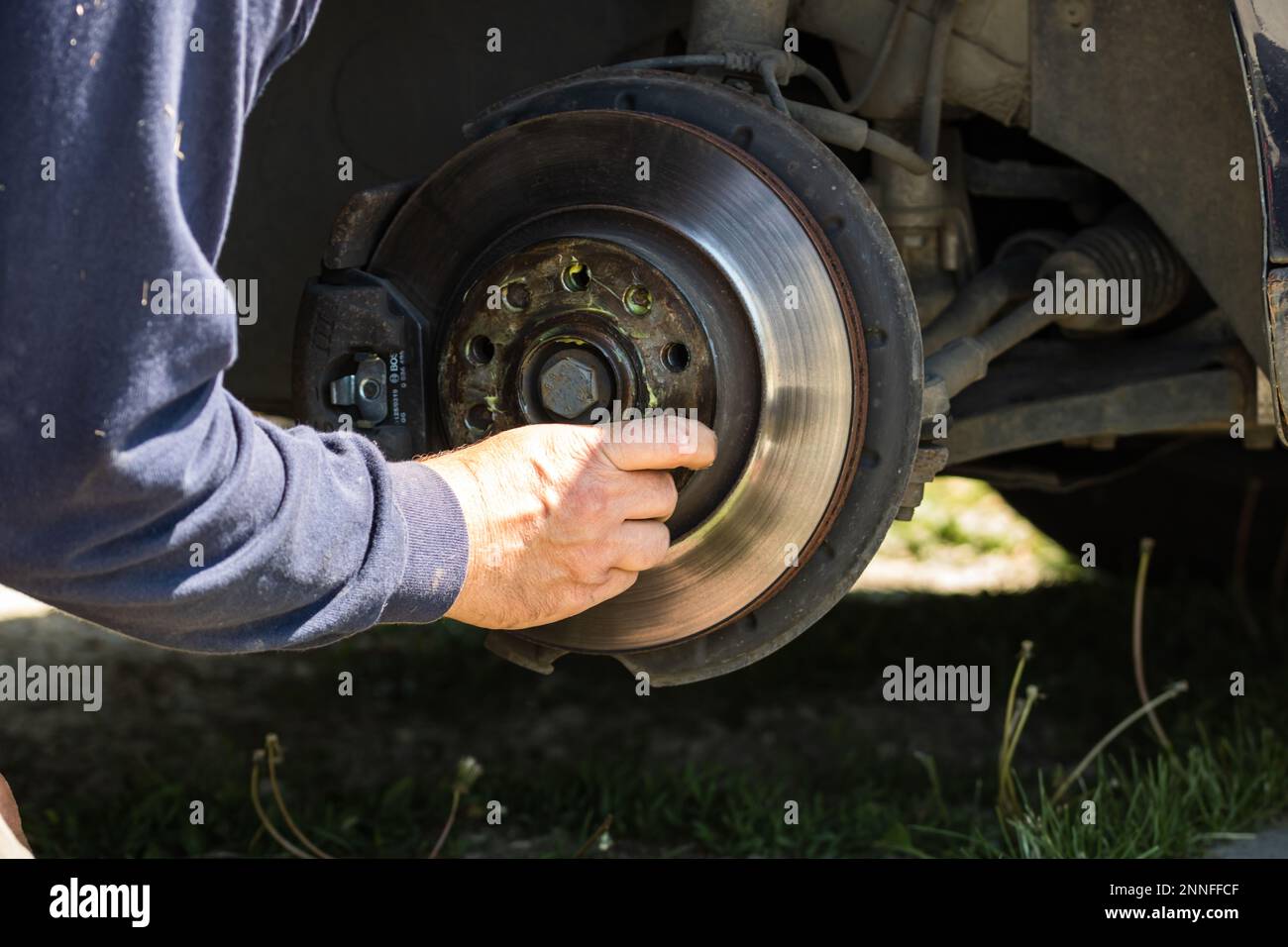 Mechanic cleaning and fixing the brake system of a car in Romania ...
