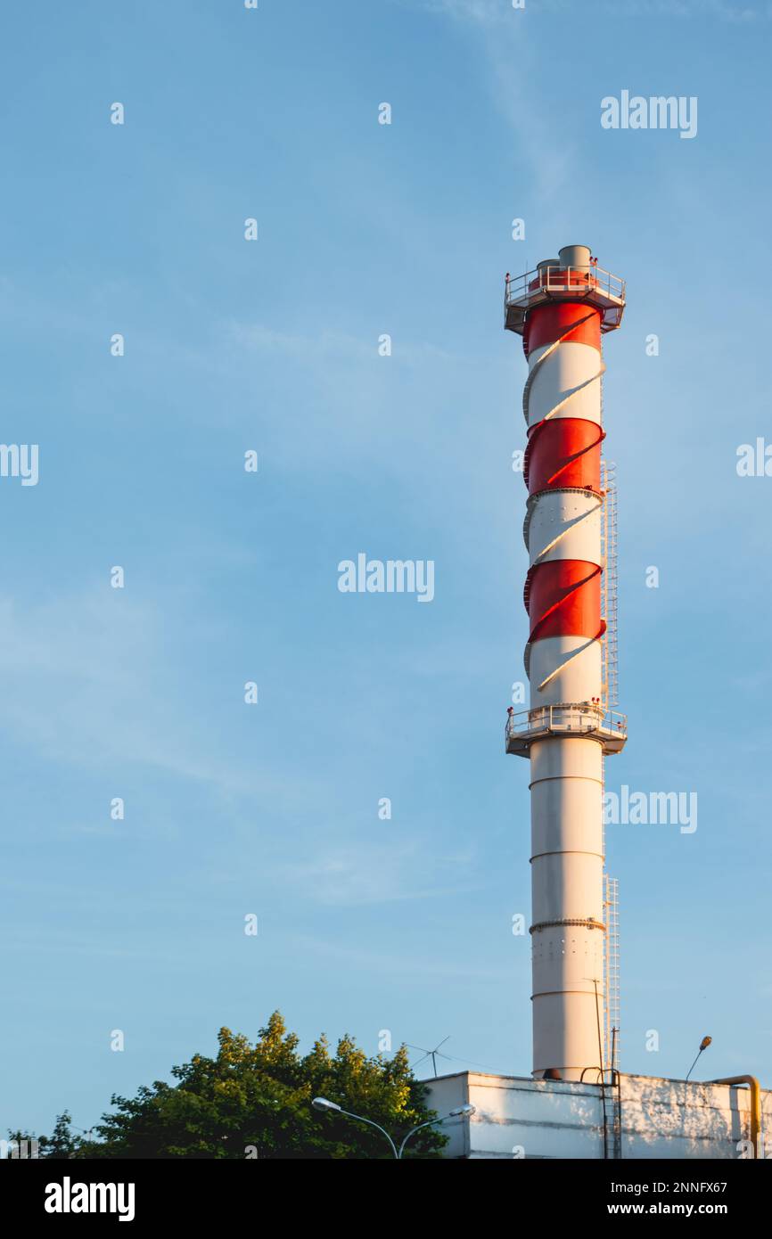 Boiler house chimney. Colorful tower against the clear blue sky ...