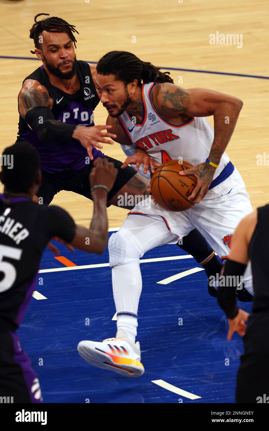 Derrick Rose, center, of the New York Knicks drives to the basket as ...
