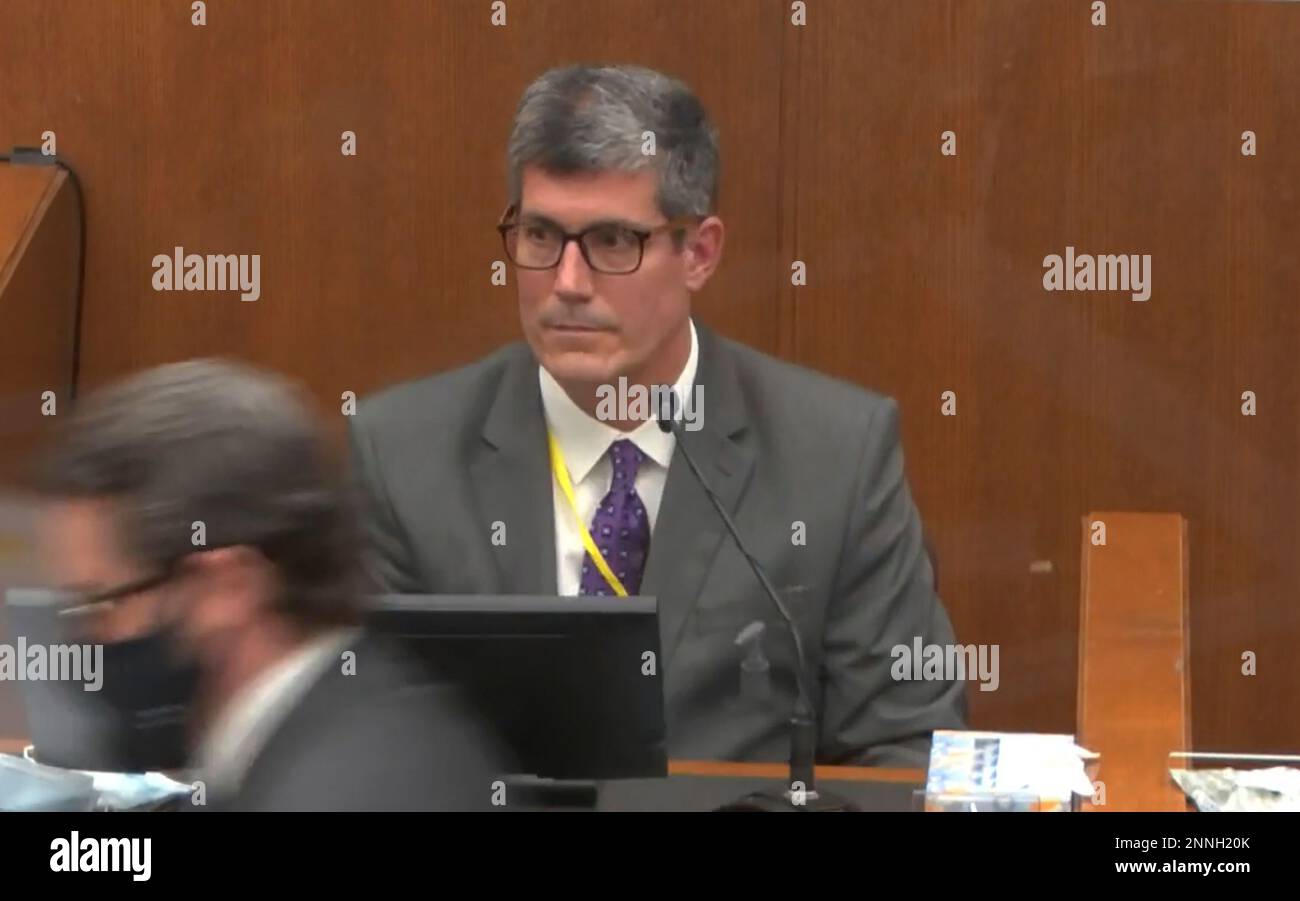 In this image from video, defense attorney Eric Nelson, left, walks ...