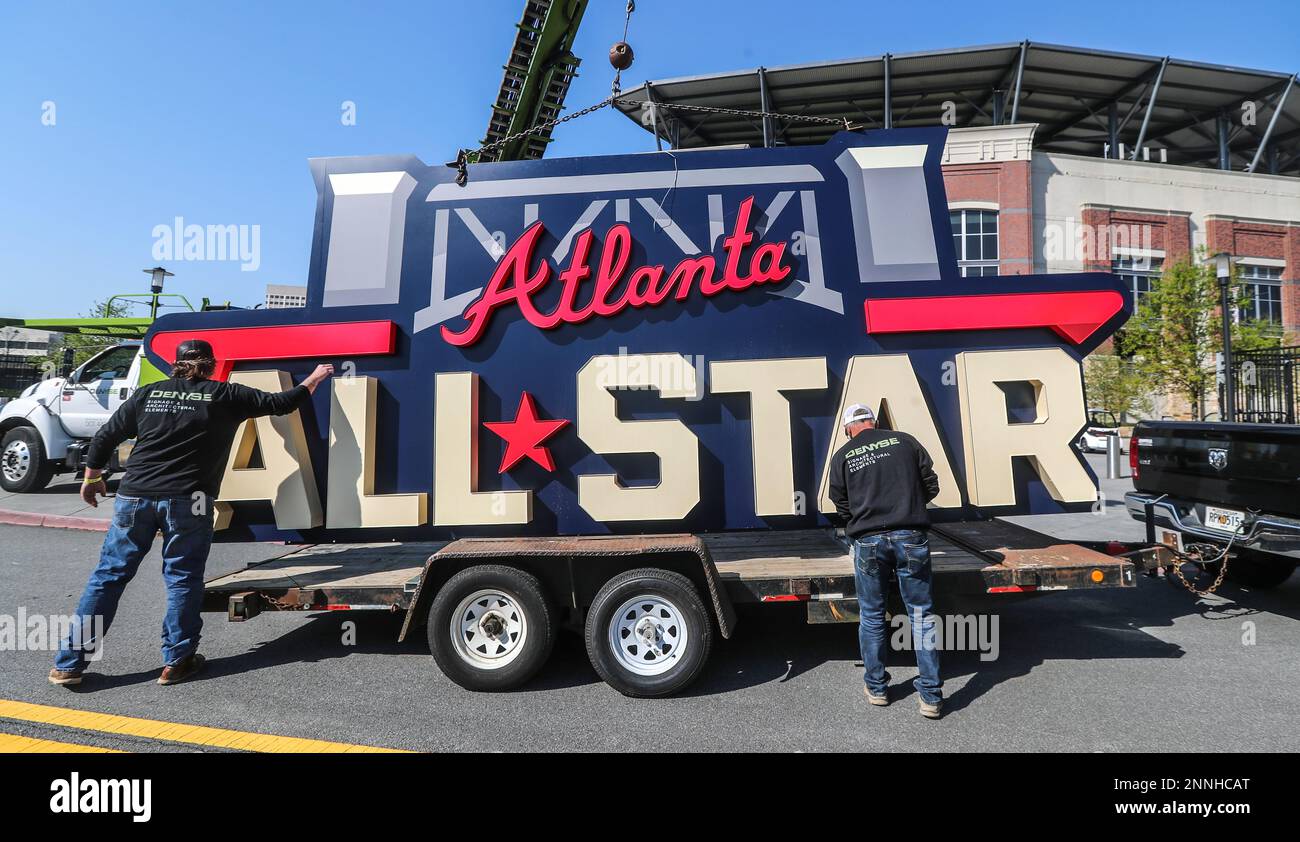 Workers load an All-Star sign onto a trailer after it was removed from ...