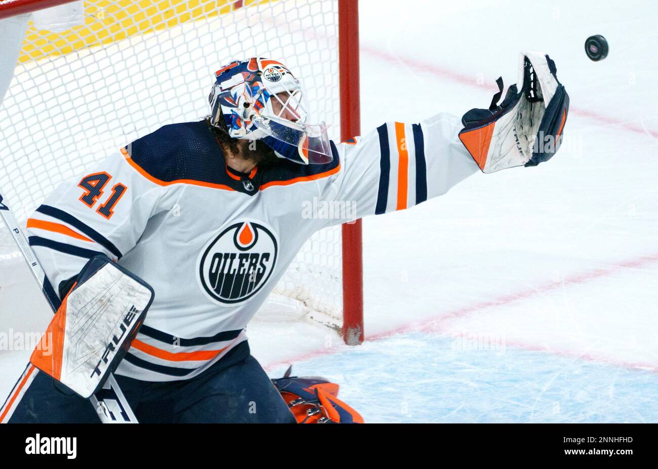 Edmonton Oilers goaltender Mike Smith rashes out for the puck during ...