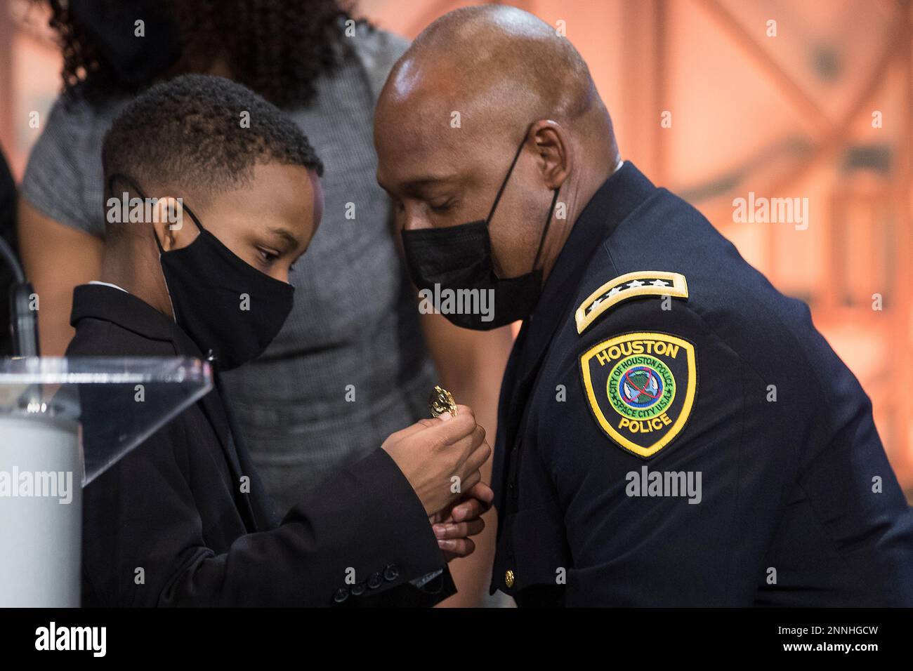 Houston Police Chief Wyatt Finner, left, pins the chief's badge on the ...