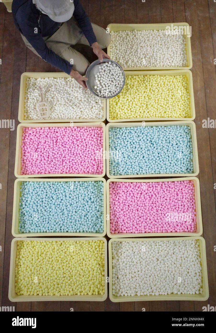 Colorful ramune soft candies are line to pack at a factory in Amagasaki ...
