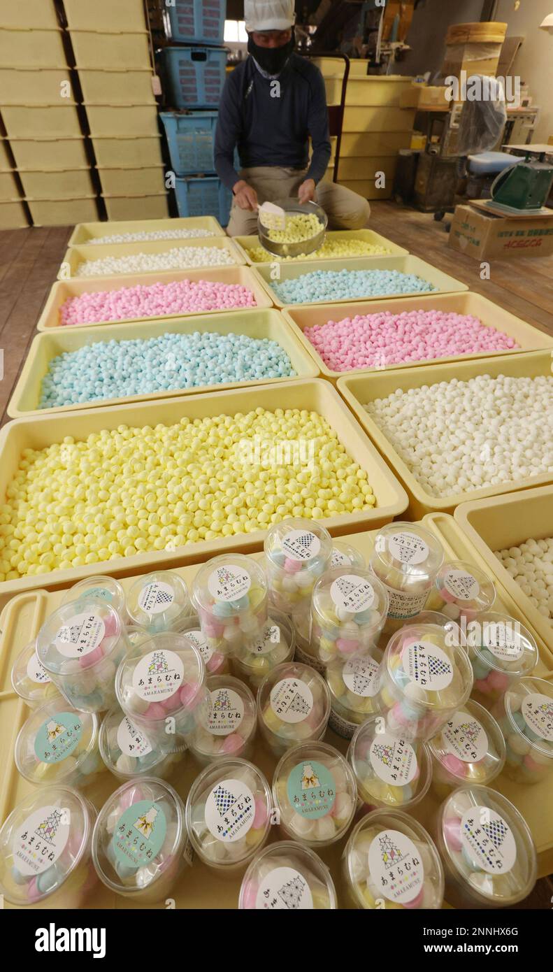 Colorful ramune soft candies are line to pack at a factory in Amagasaki ...