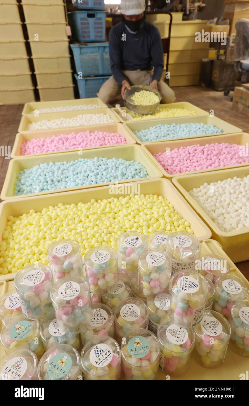 Colorful ramune soft candies are line to pack at a factory in Amagasaki ...