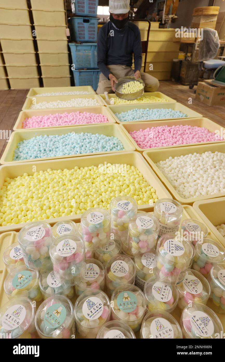 Colorful ramune soft candies are line to pack at a factory in Amagasaki ...
