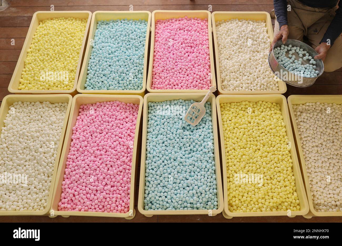 Colorful ramune soft candies are line to pack at a factory in Amagasaki ...
