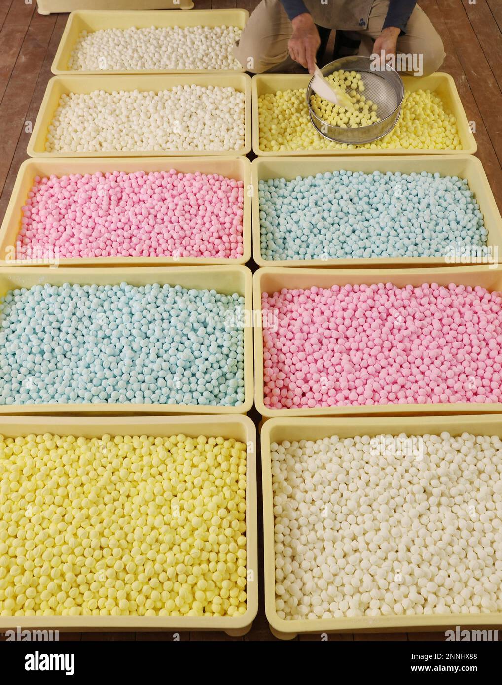 Colorful ramune soft candies are line to pack at a factory in Amagasaki ...