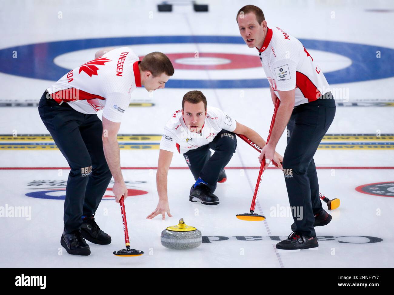 Team Canada skip Brendan Bottcher, center, makes a shot as lead Karrick ...
