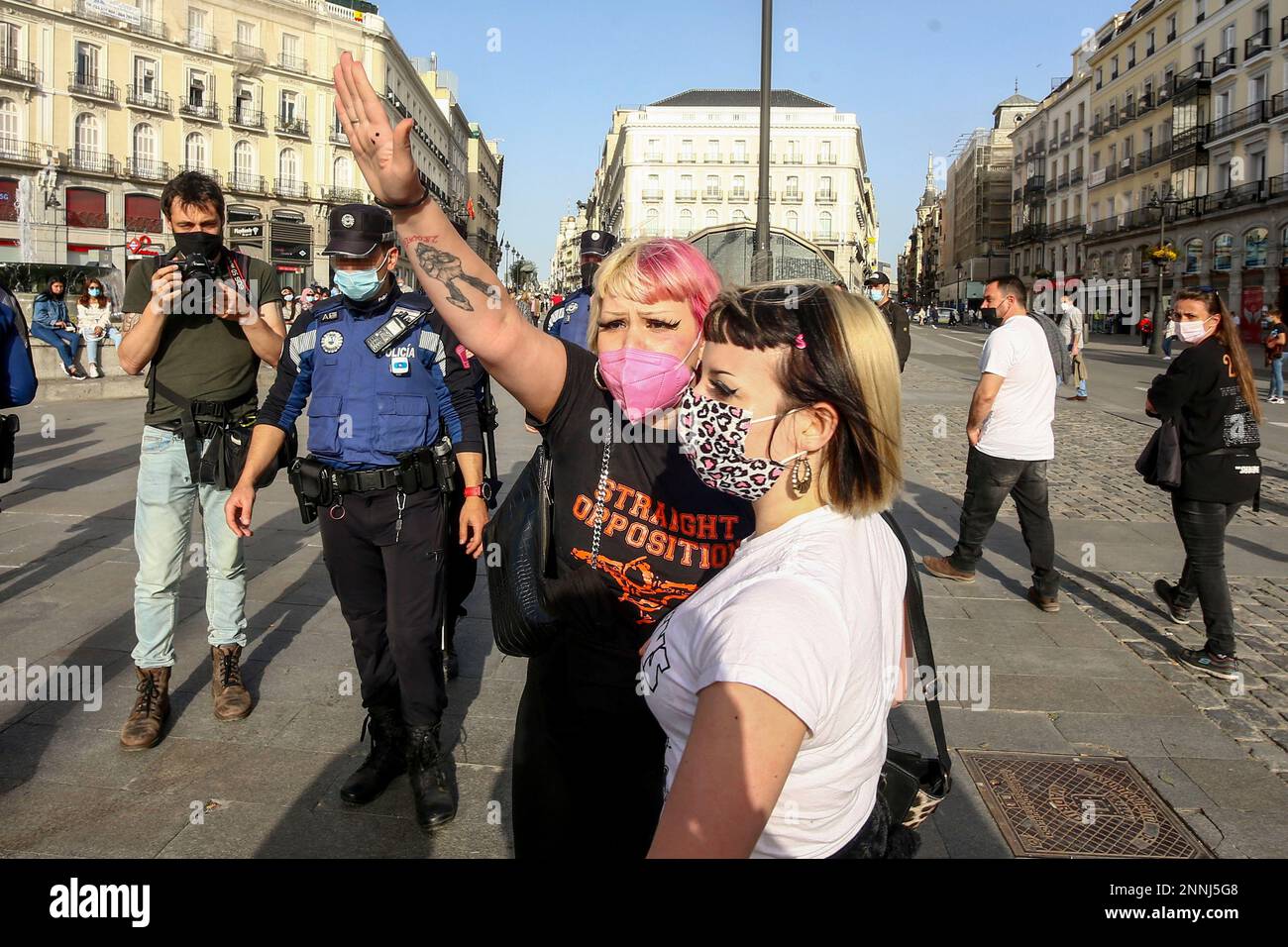 A neo-Nazi performs the Roman salute in front of a rally for ...