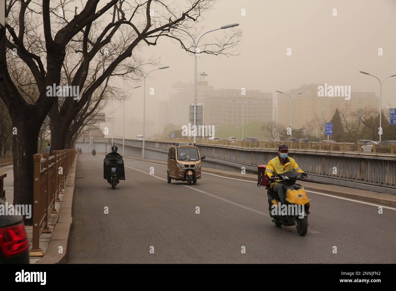 Sandstorm covers people in yellow dust at Beijing's street on March 28 ...
