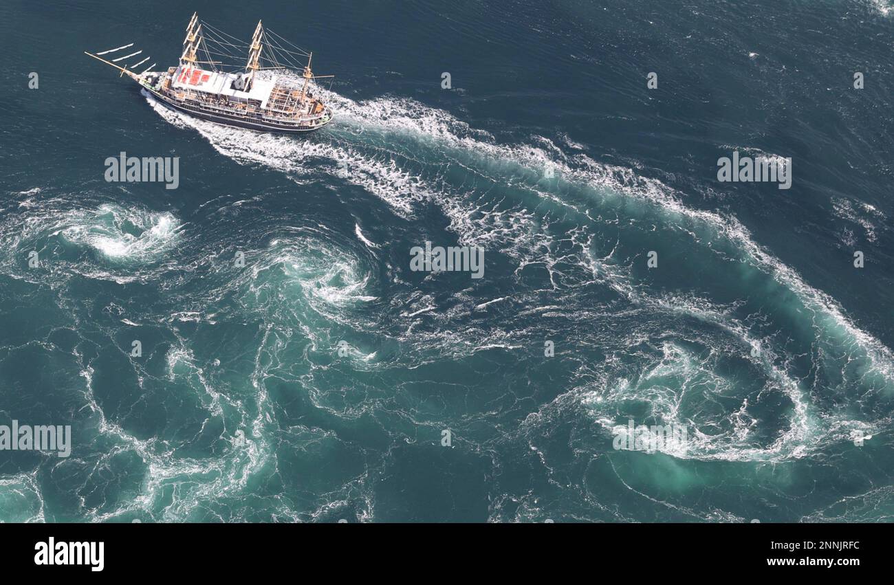 An aerial picture shows a tour boat cruising in the middle of Naruto ...