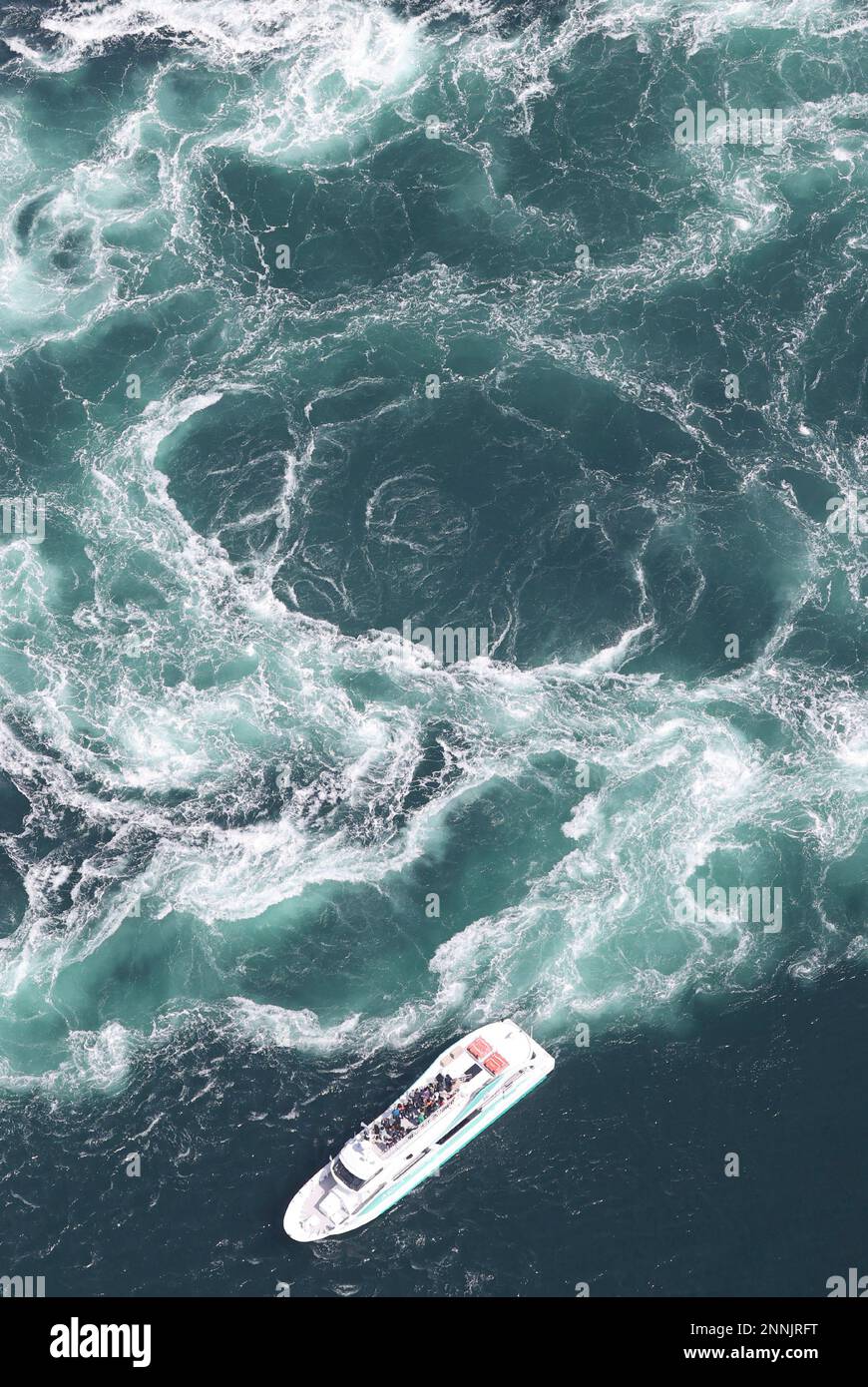 An aerial picture shows a tour boat cruising in the middle of Naruto ...