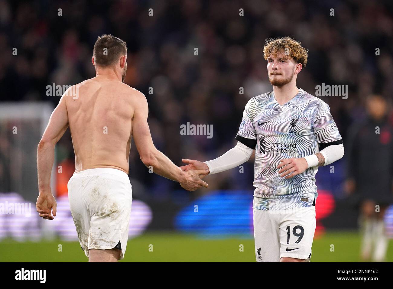 Liverpool's James Milner (left) greets Harvey Elliott following the ...
