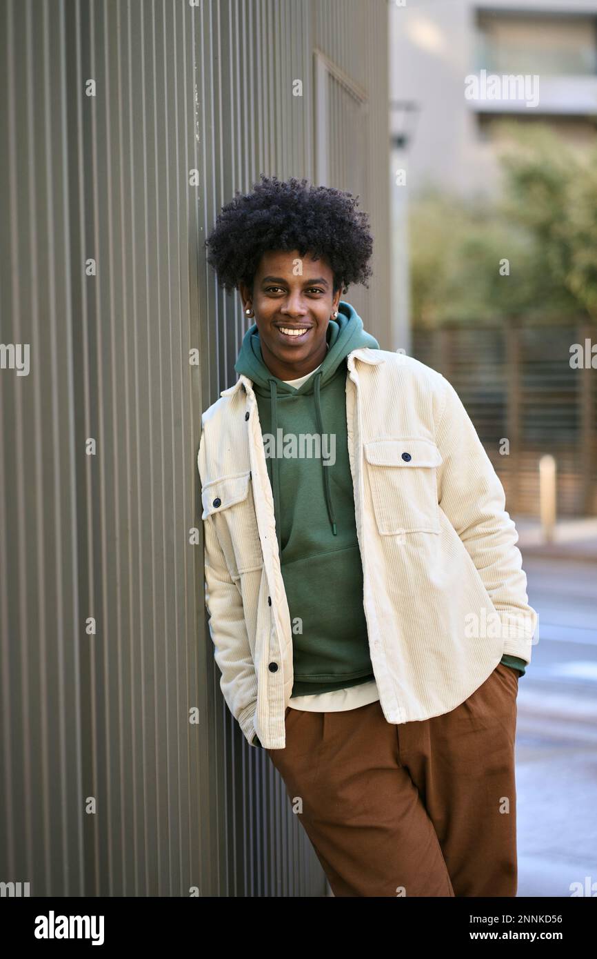 Happy cool gen z African American hipster guy standing at city street ...