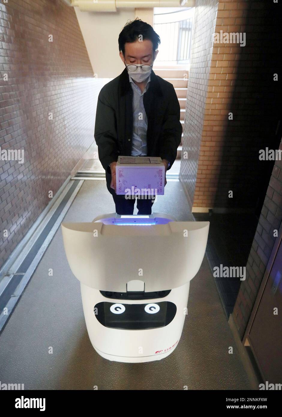 Japan Post Group (JP) conducts a demonstration of a robotic delivery ...