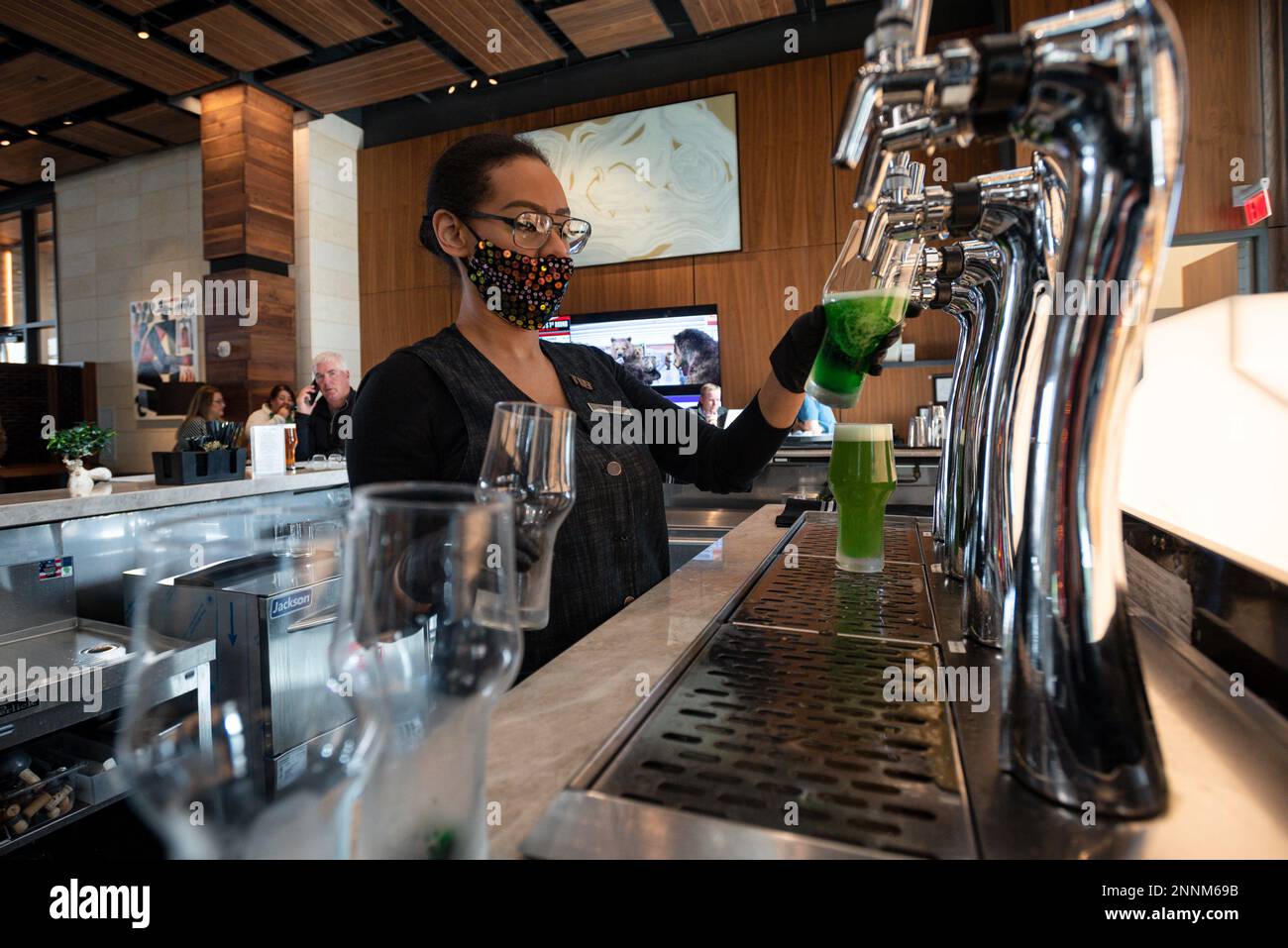 Bartender Shardae Briggs pours green beers at the Odessa Marriott Hotel ...