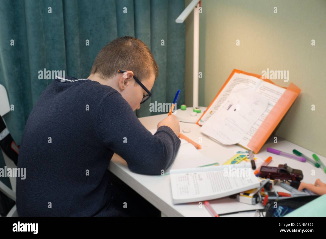 student doing homework sitting at desk at home Stock Photo - Alamy
